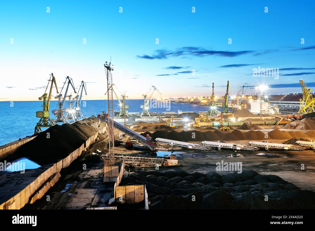 Maritime Bulk Terminal dry cargo handling at night Stock Photo - Alamy