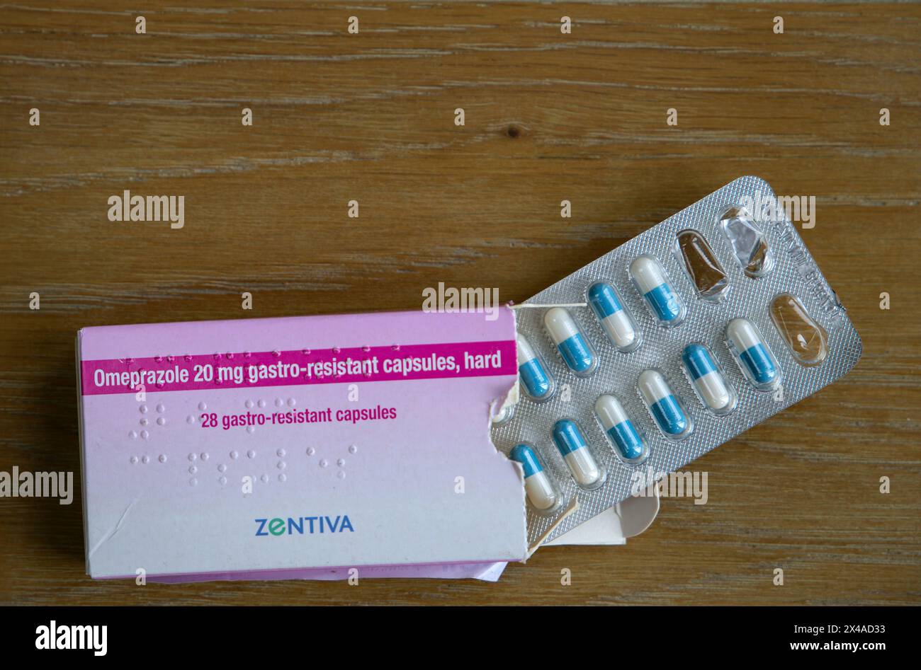 Omeprazole 20 mg gastro-resistant capsules in blister pack next to its ...