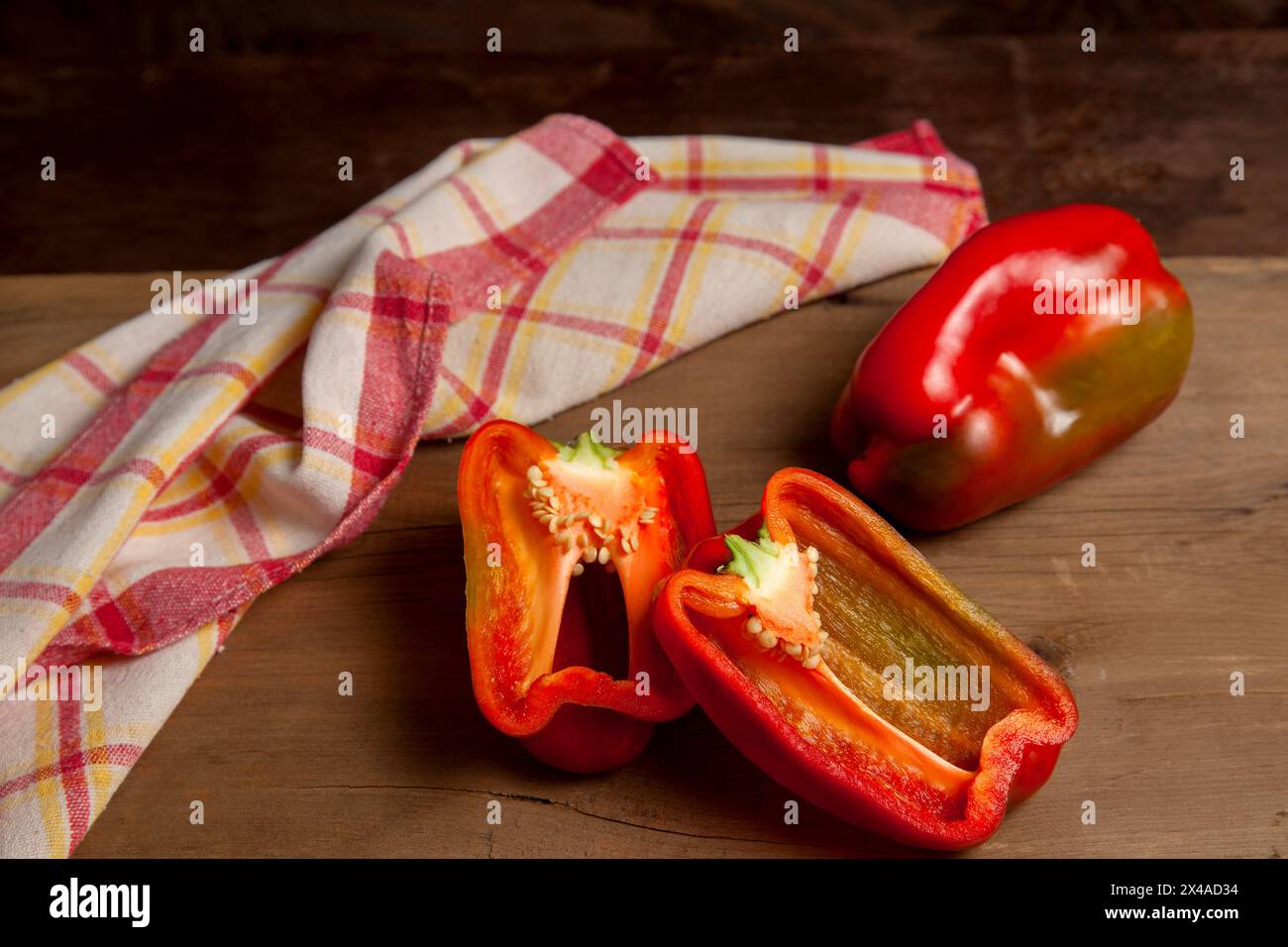 Whole and half red bell pepper (capsicum) known as sweet bell pepper ...