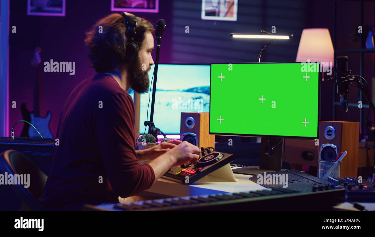 Music producer learning to use mixing console with online tutorial on ...