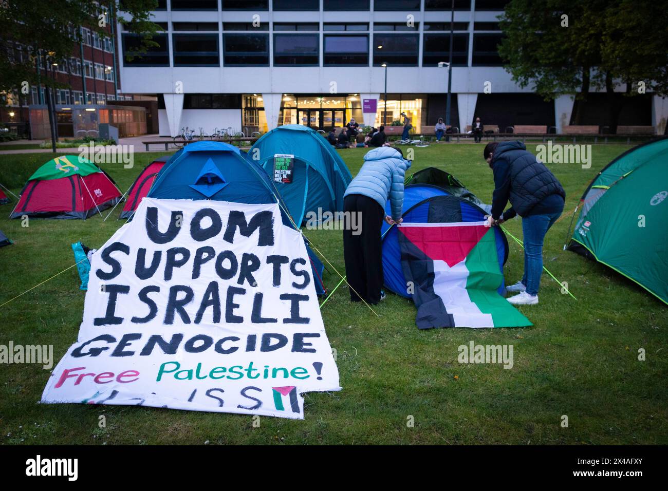 Manchester, UK. 01st May, 2024. Activists lay flags on tents at the ...