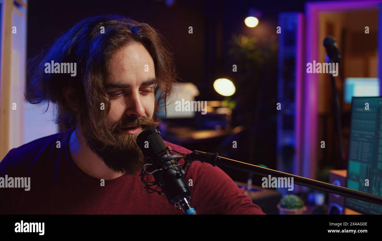 Artist singing a song at microphone and playing electronic piano to ...