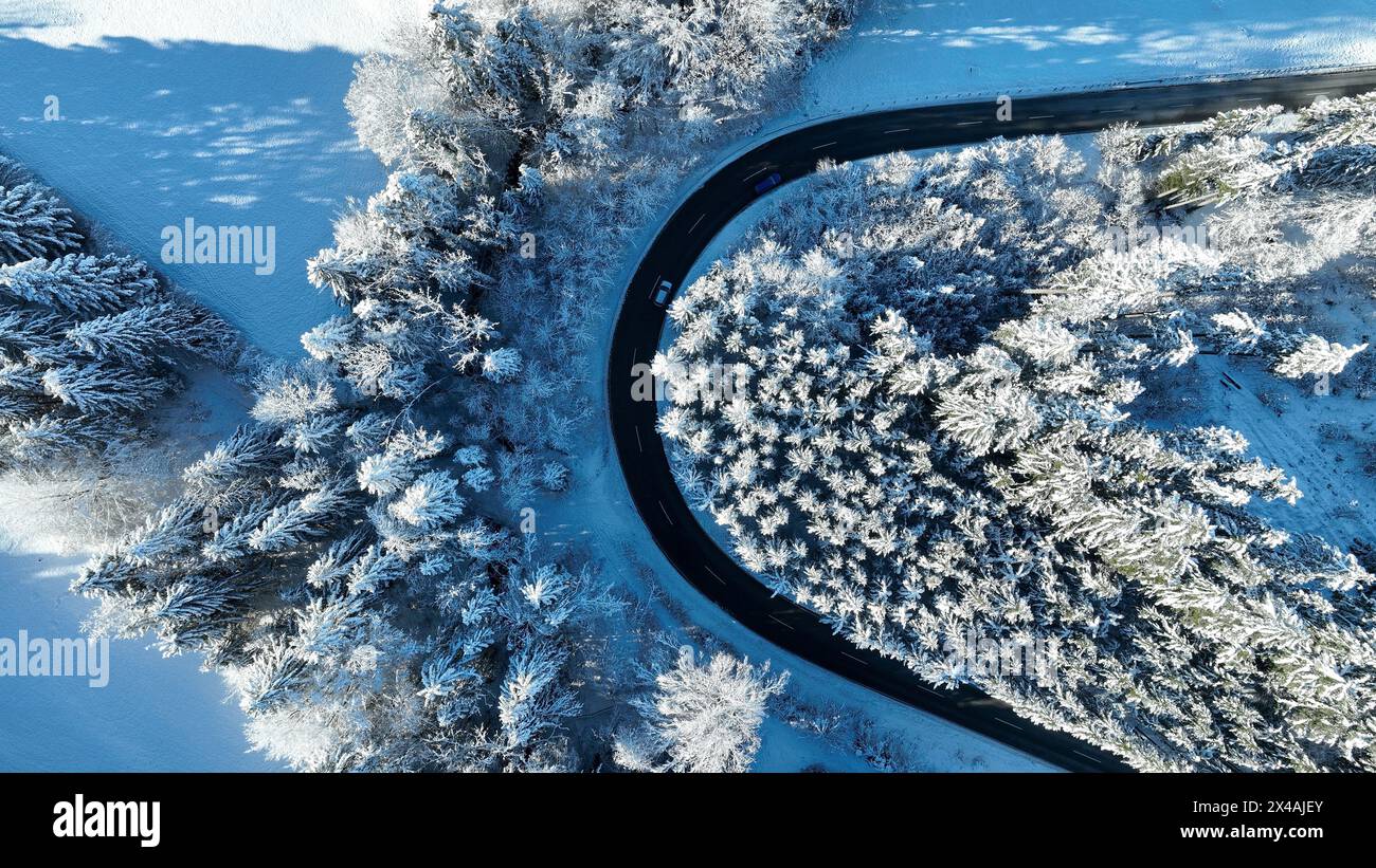 Drone photo of a sharp bend in the road with traffic in winter Stock ...