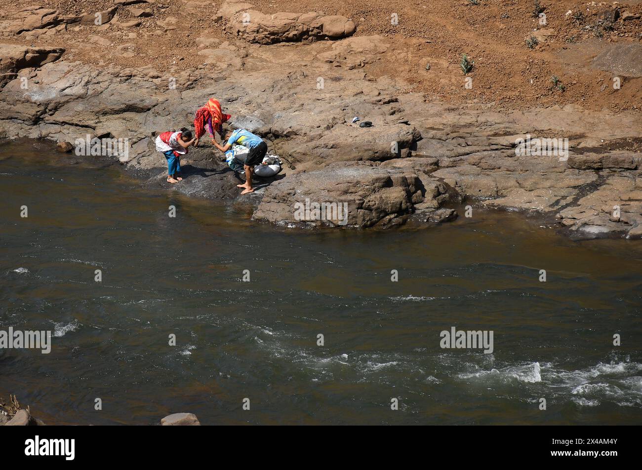 Villagers are seen washing clothes on the banks of Vaitarna river near ...