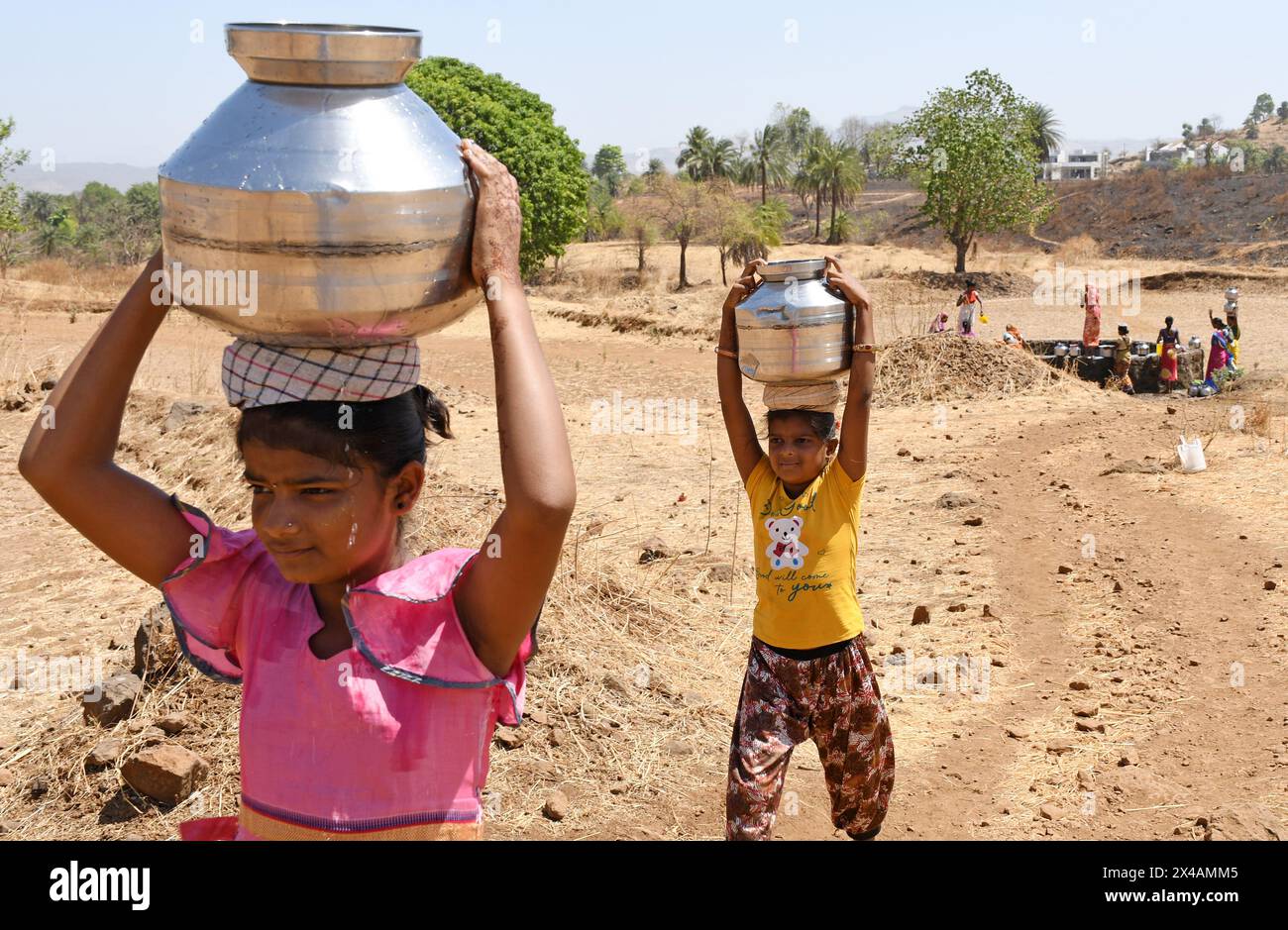 Young girls carry water in vessels near Vihigaon village, Shahapur ...