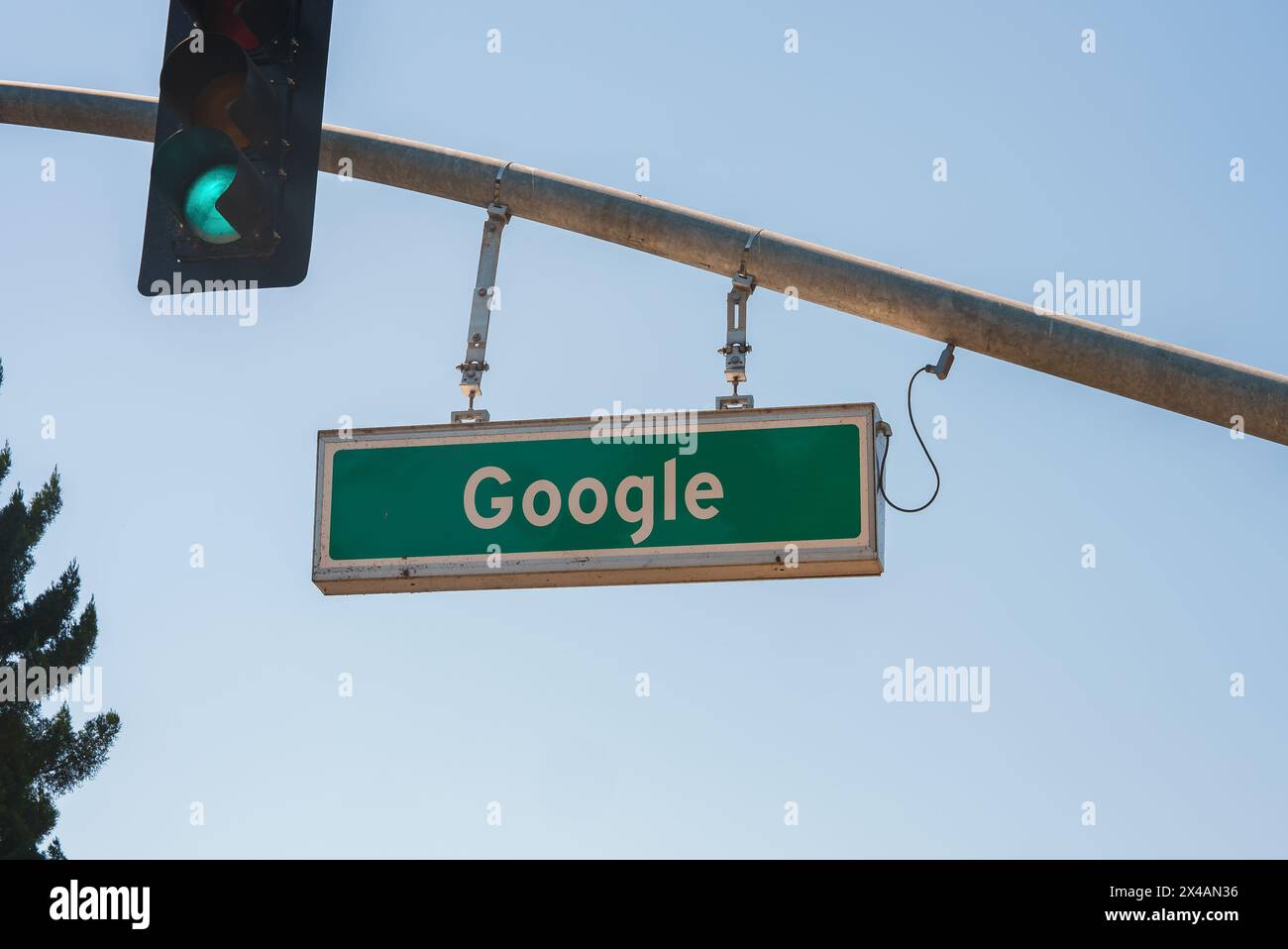 Google street sign at headquarters with green light, clear sky ...