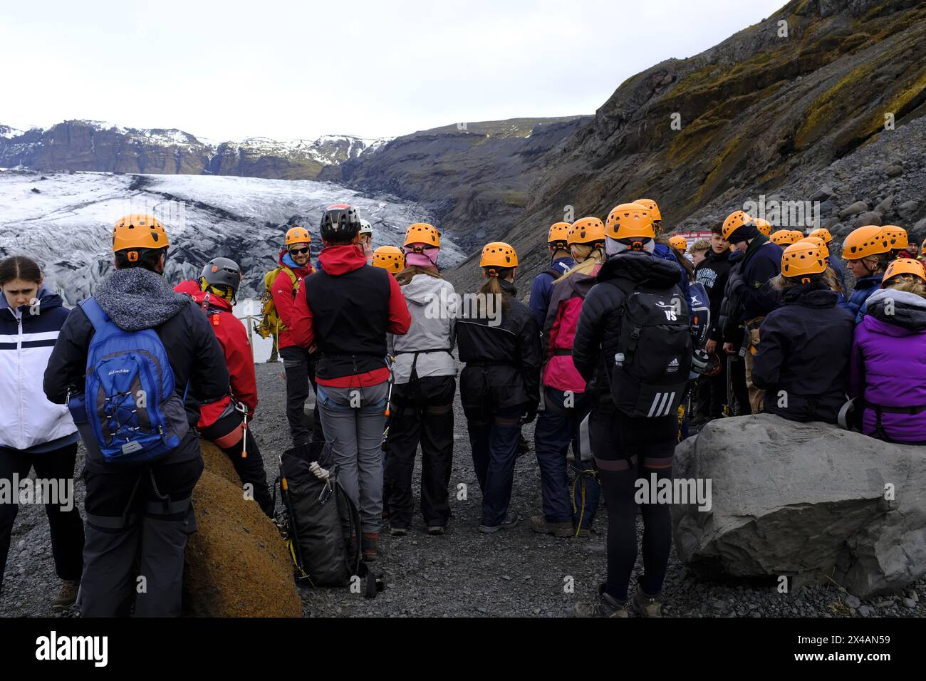 group of people taking an expedition in the Sólheimajökull Glaciar ...