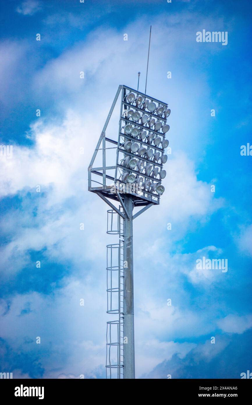 Stadium lights with dramatic sky background. This image is suitable for ...