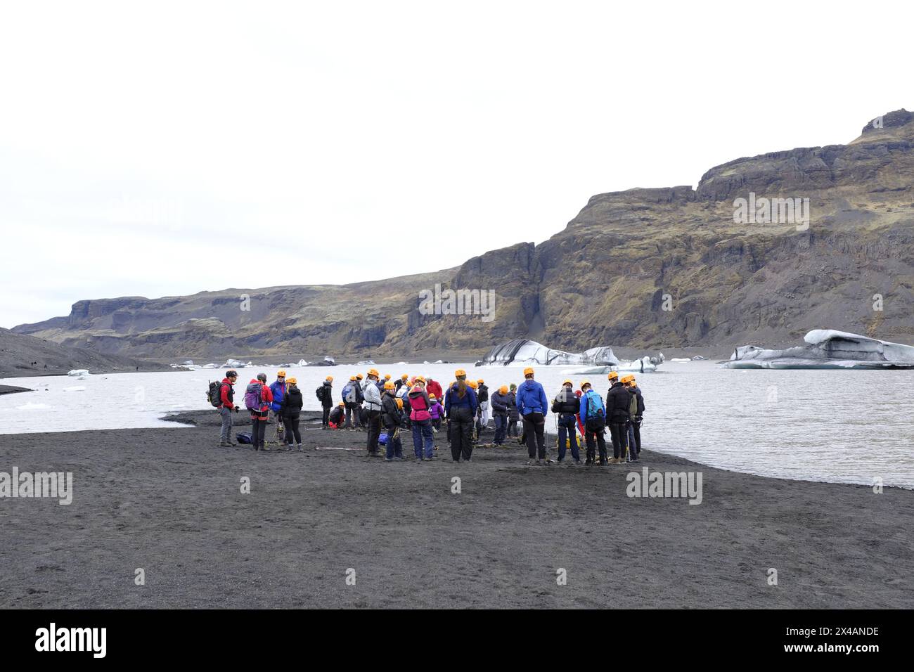 group of people taking an expedition in the Sólheimajökull Glaciar ...