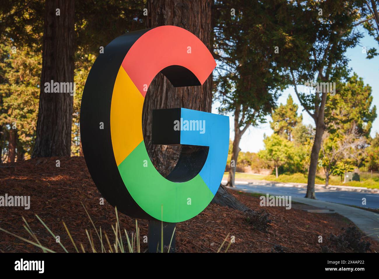 Colorful 3D 'G' Sign in Park Setting for Google in Suburban Environment ...