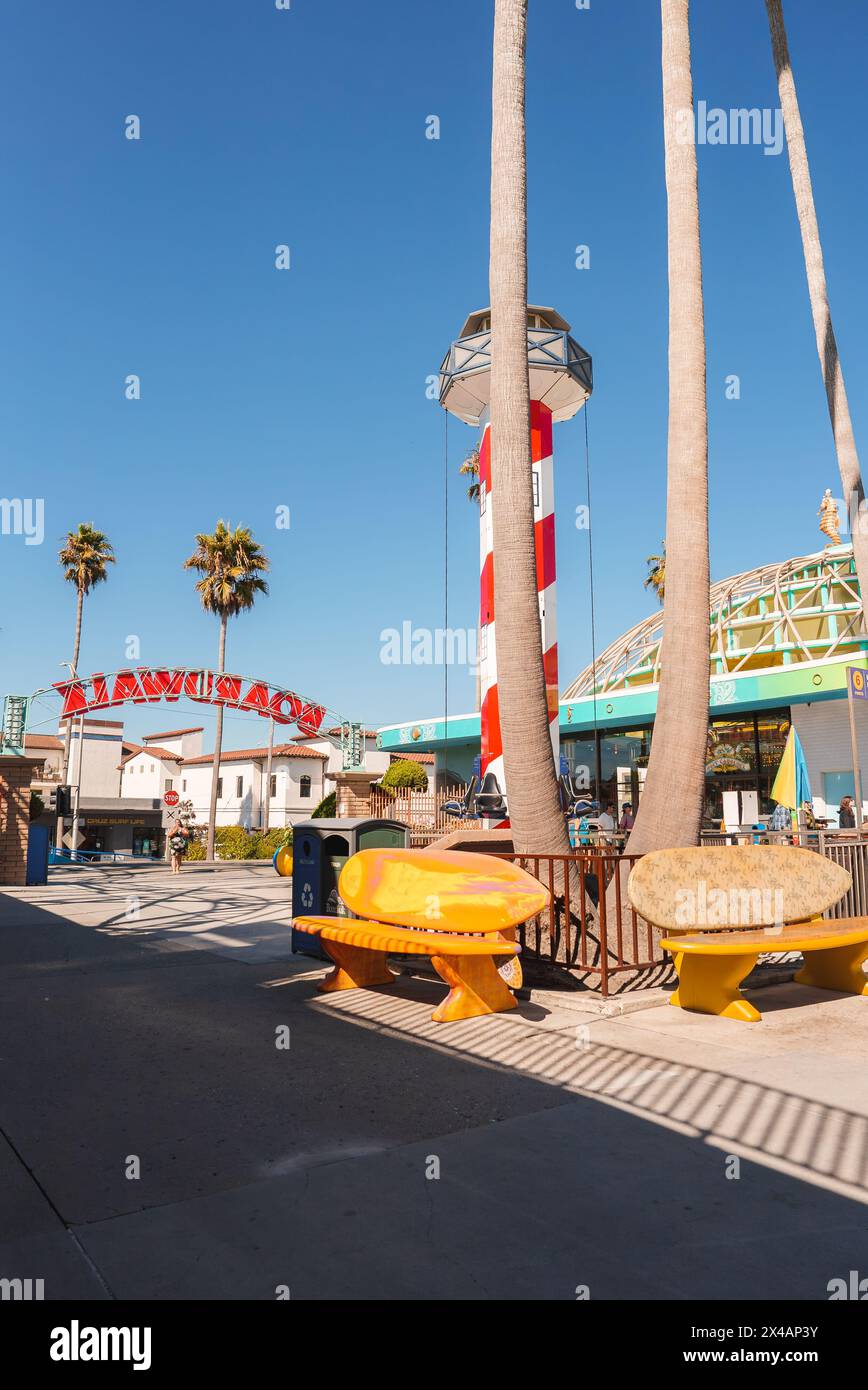 Tropical amusement park, beach tower with palm trees, benches and ...