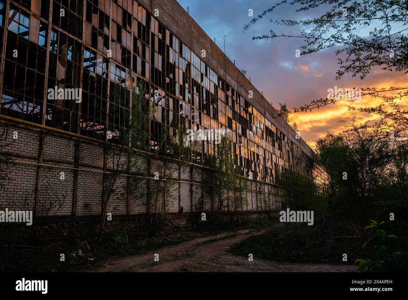 Old abandoned industrial building at sunset Stock Photo - Alamy
