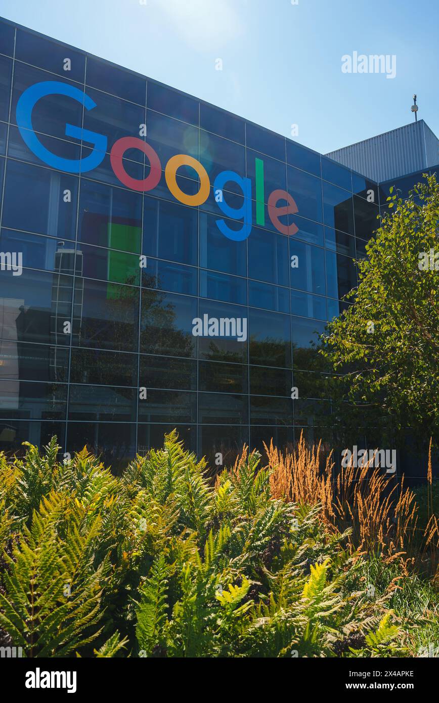 Modern building with colorful Google logo, plants, and clear blue sky ...