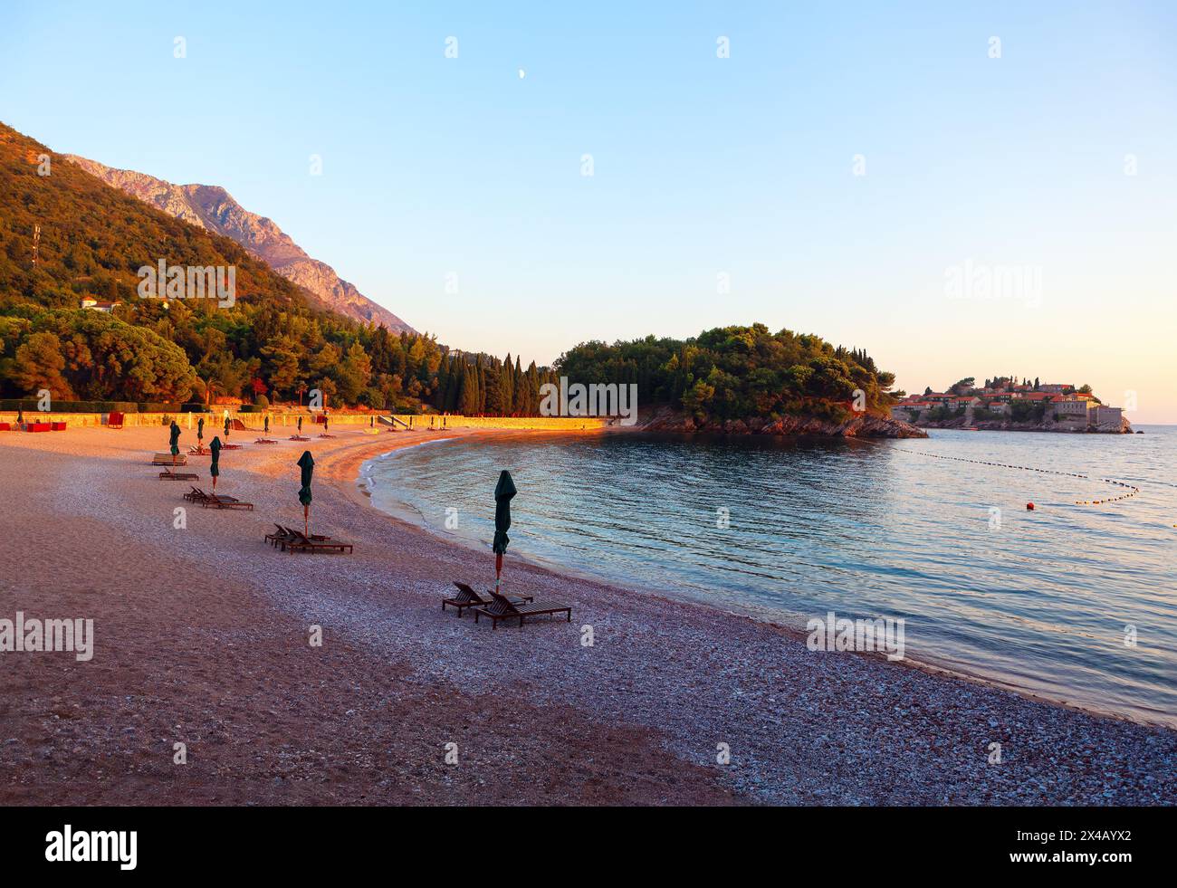 Sunset on the beach in Sveti Stefan, Montenegro. Milocer beach in Budva ...