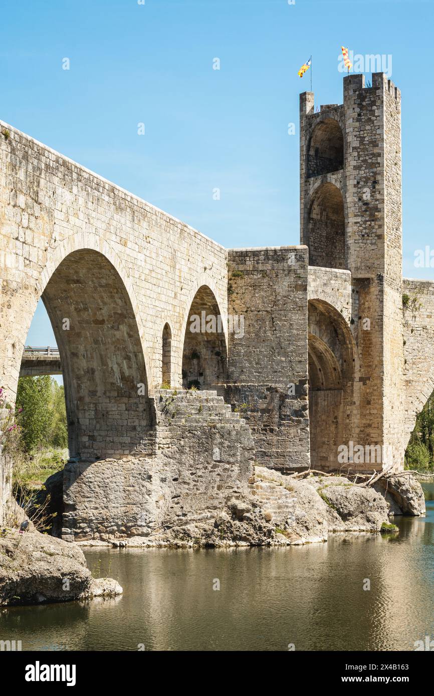 The bridge of the medieval village of Besalú with a tower in the ...