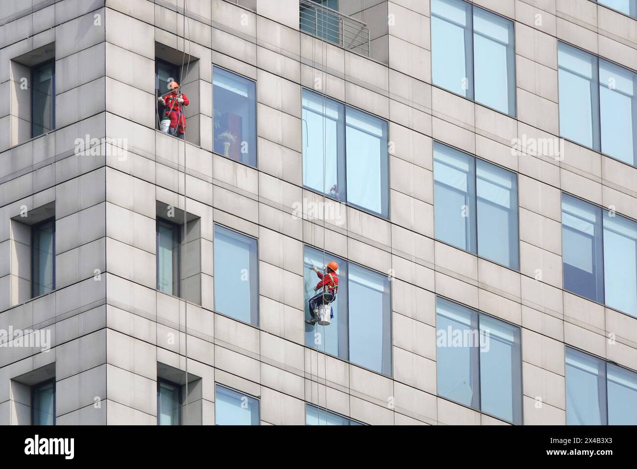 BEIJING, CHINA - MAY 1, 2024 - Workers clean the Windows on each floor ...