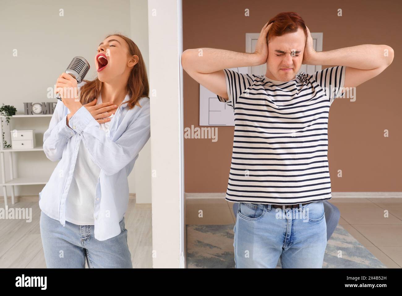 Young man suffering from loud neighbour singing at home Stock Photo - Alamy