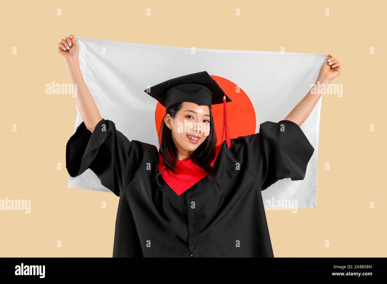 Female Asian graduate with flag of Japan on beige background Stock ...
