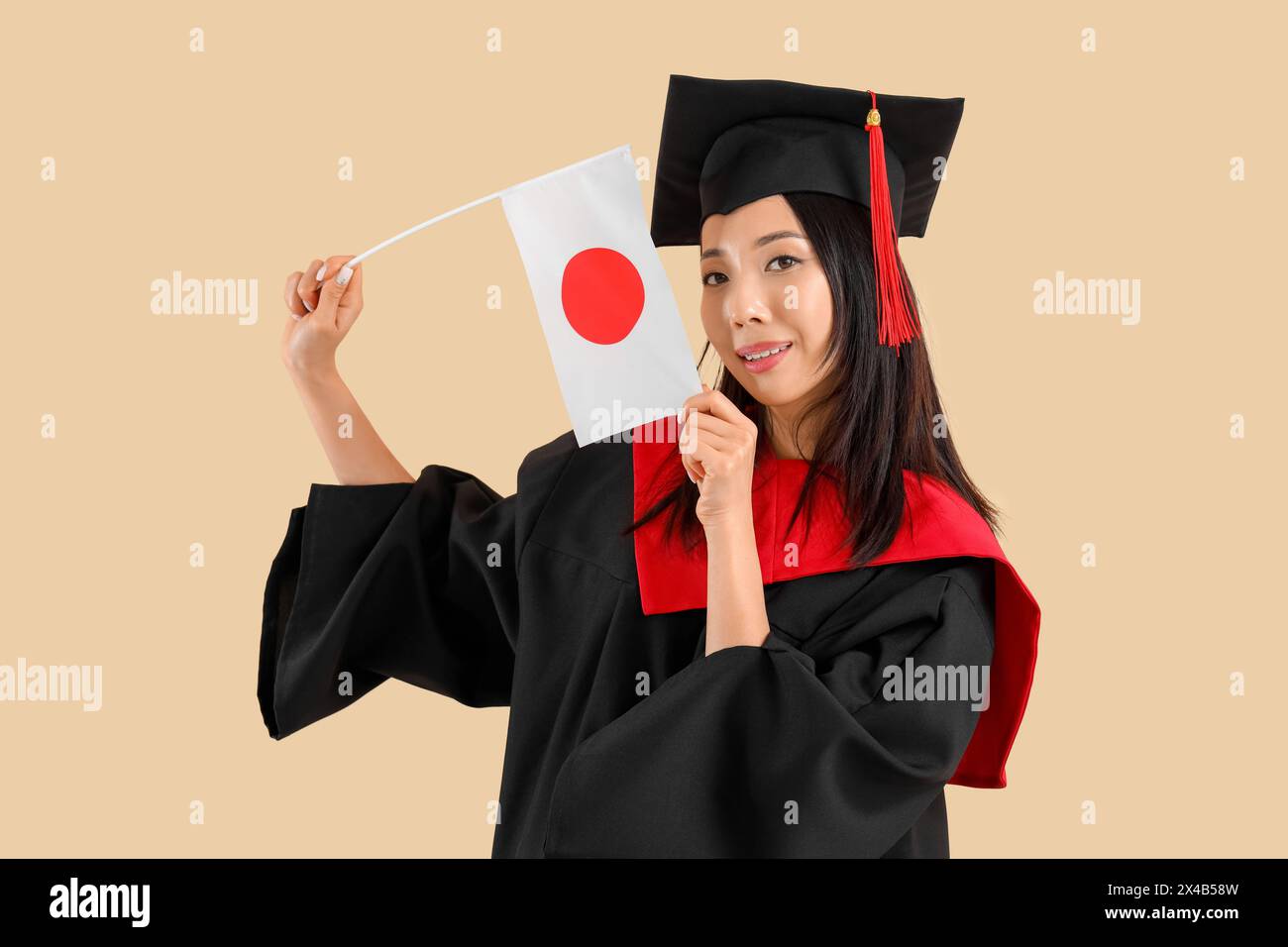 Female Asian graduate with flag of Japan on beige background Stock ...