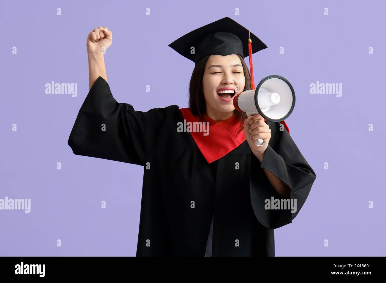 Young female graduate with megaphone on lilac background Stock Photo ...
