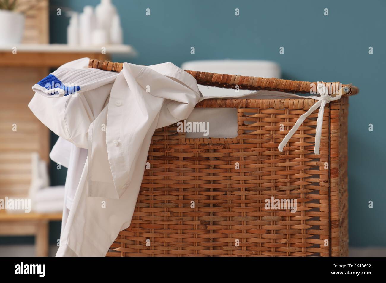 Full laundry basket in room, closeup Stock Photo - Alamy
