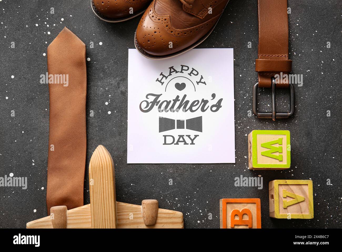 Different son and father accessories on black background Stock Photo ...