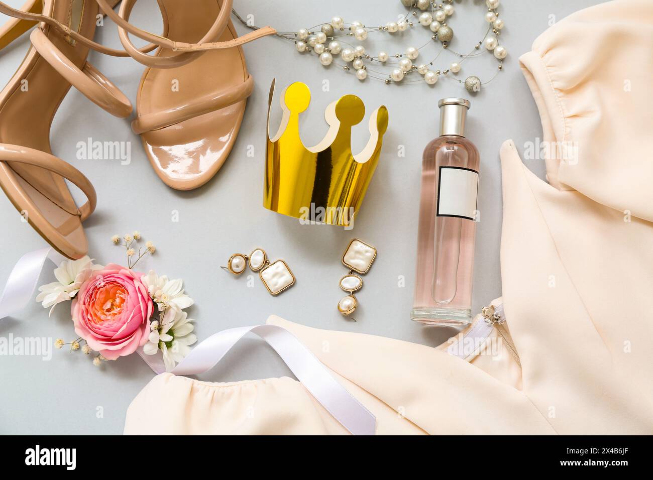 Female prom outfit with crown, perfume bottle and accessories on white ...