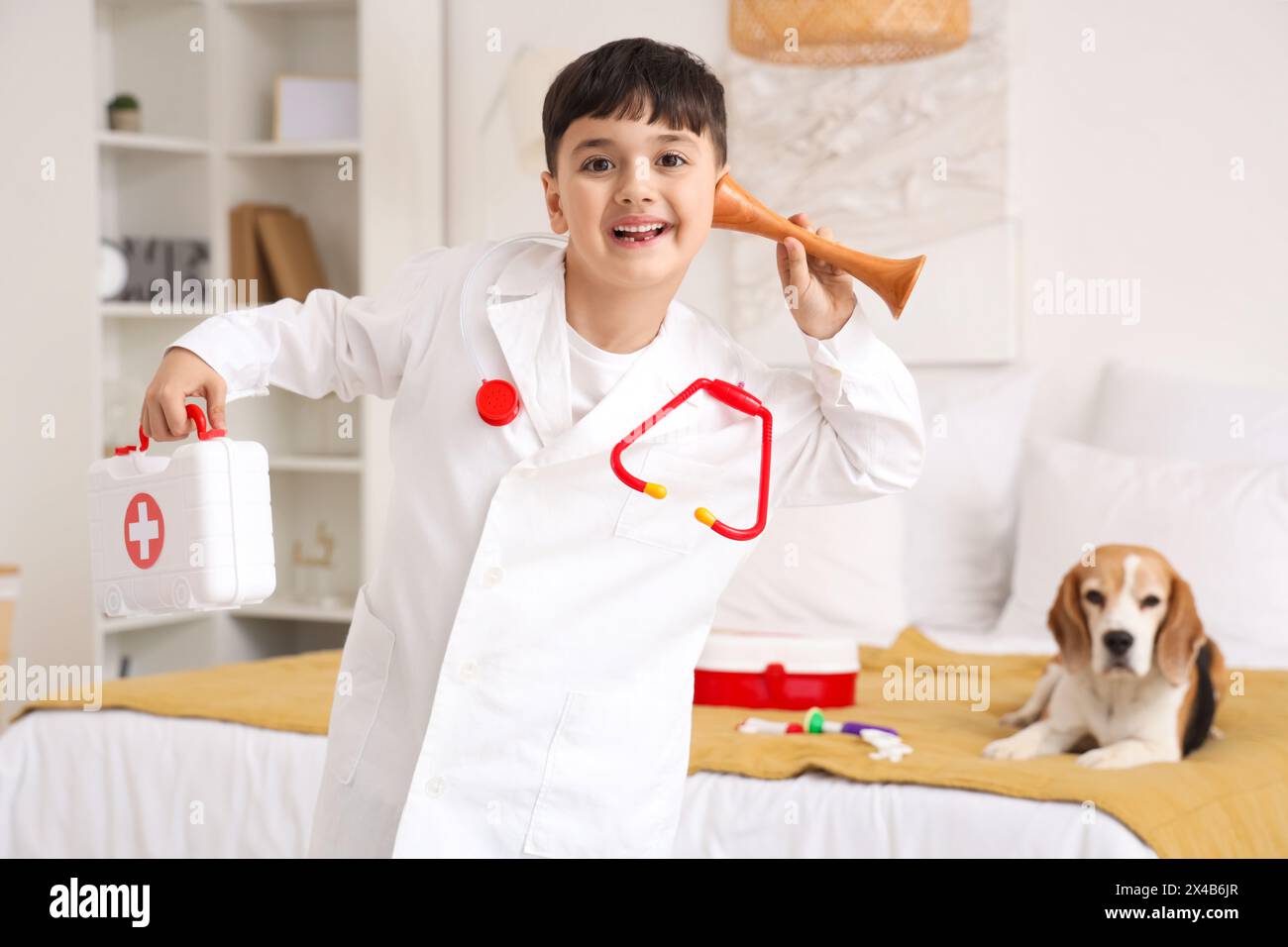 Cute little doctor with first aid kit and stethoscope in bedroom Stock ...