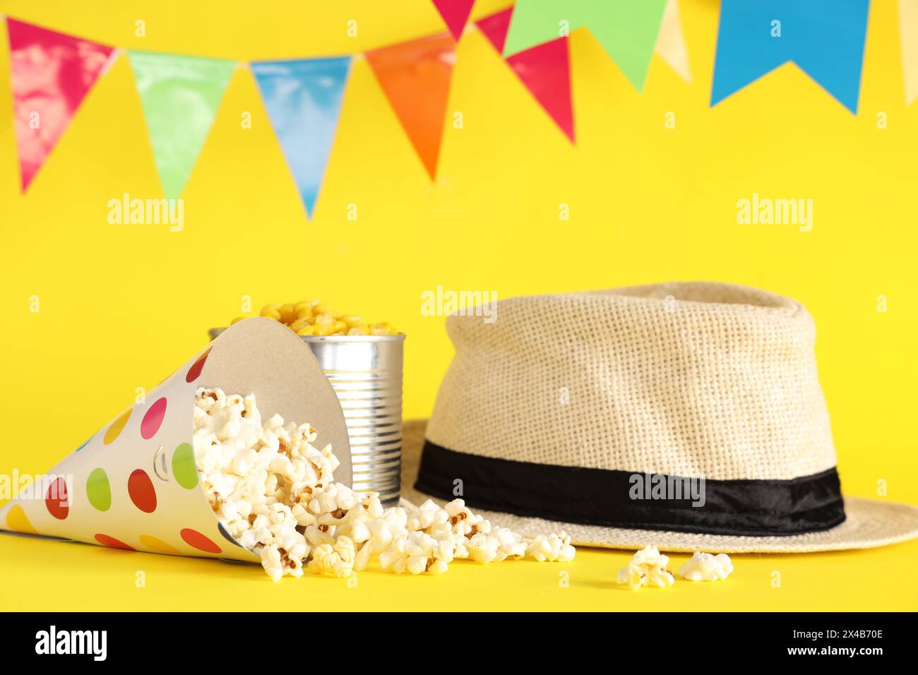 Straw hat, tasty popcorn, corn and flags for Festa Junina celebration on yellow background Stock ...
