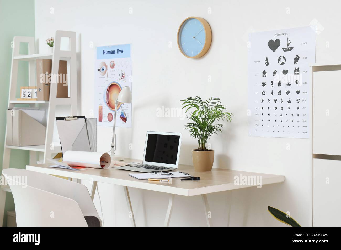 Interior of ophthalmologist's office with workplace and eye test chart ...