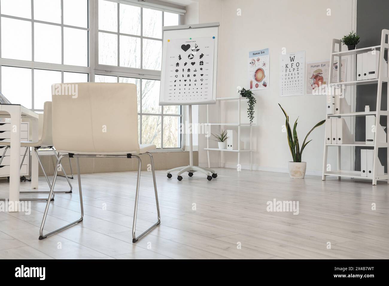 Interior of oculist's office with eye test charts and shelf units Stock ...