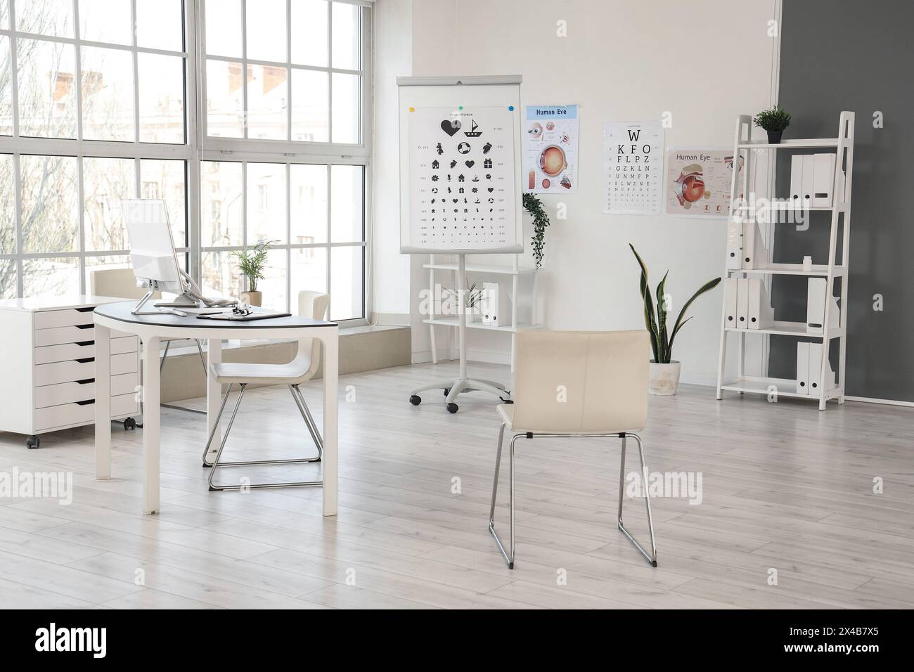 Interior of oculist's office with workplace and eye test charts Stock ...
