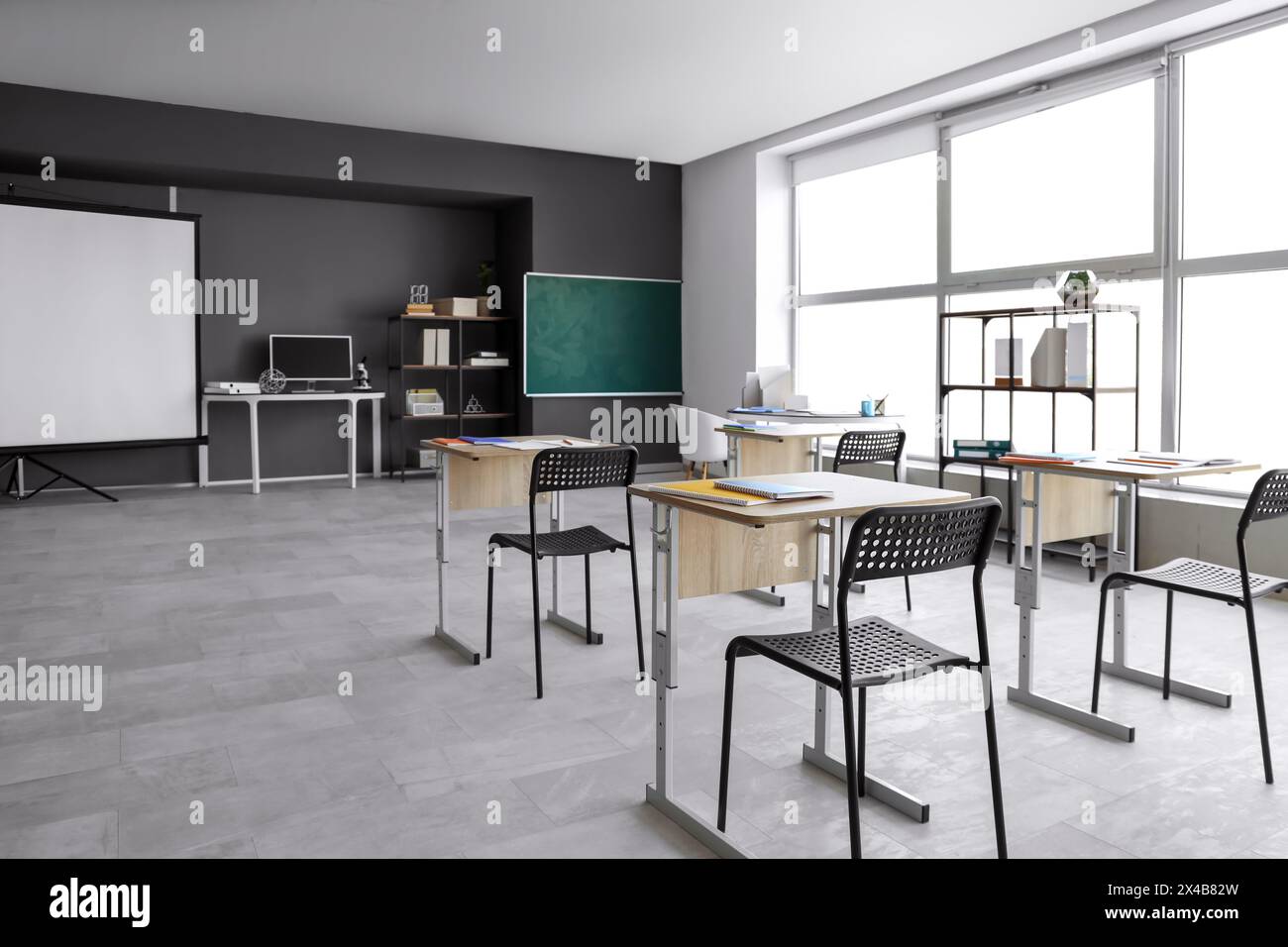 Interior of empty classroom with desks and chalkboard Stock Photo - Alamy