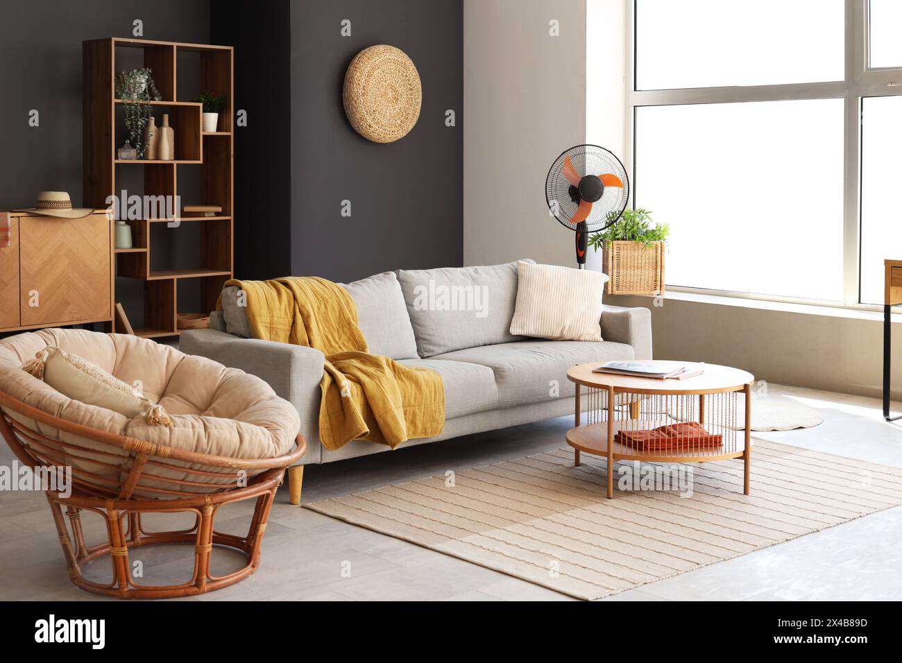 Interior of stylish living room with modern electric fan and grey sofa ...