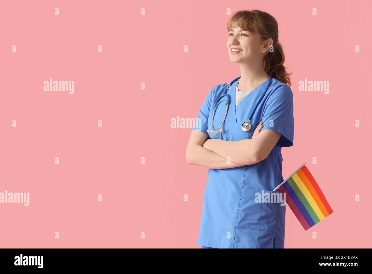 Female doctor with LGBT flag on pink background Stock Photo - Alamy