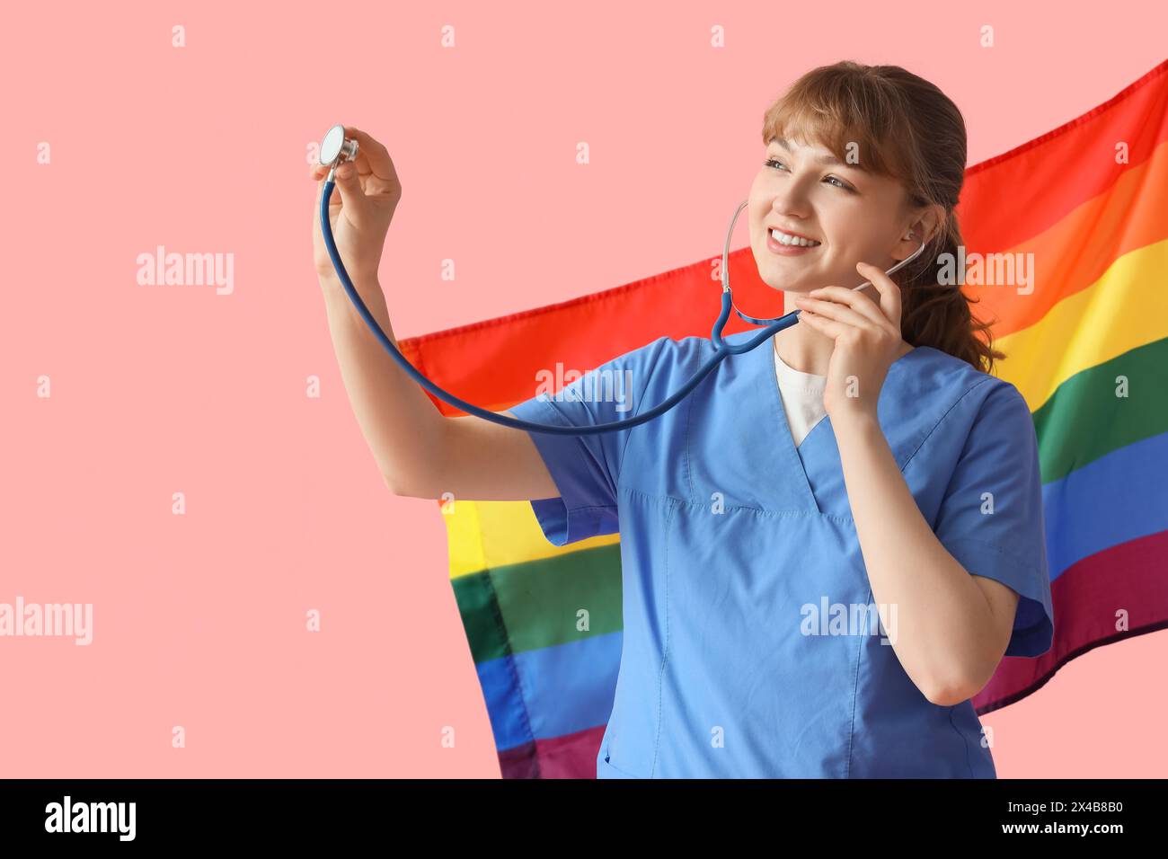 Female doctor with stethoscope and LGBT flag on pink background Stock ...