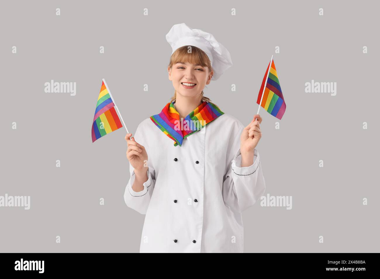 Female chef with LGBT flags on light background Stock Photo - Alamy
