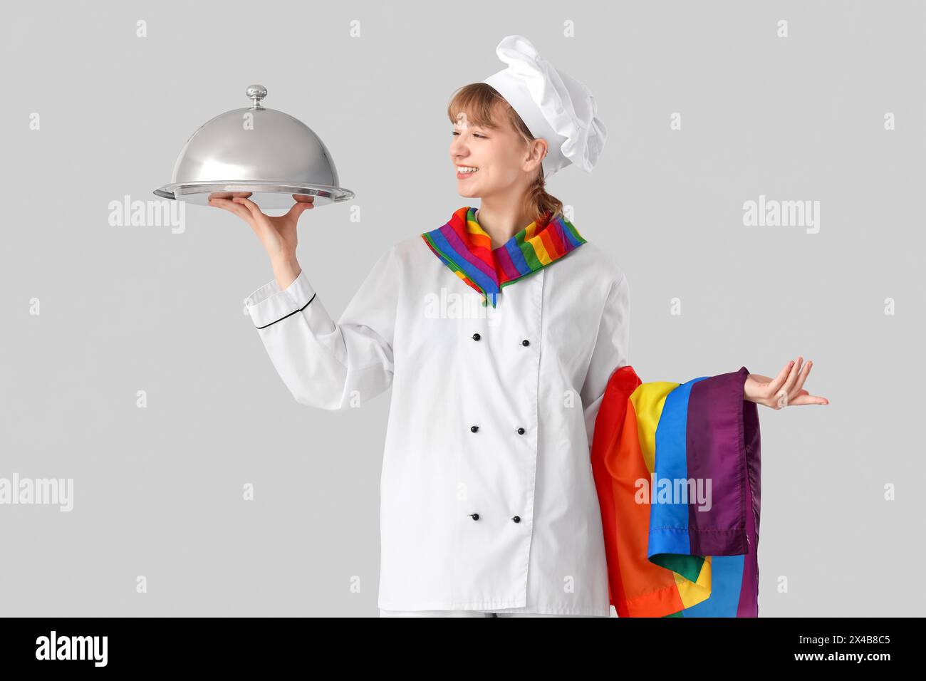 Female chef with LGBT flag and cloche on light background Stock Photo ...