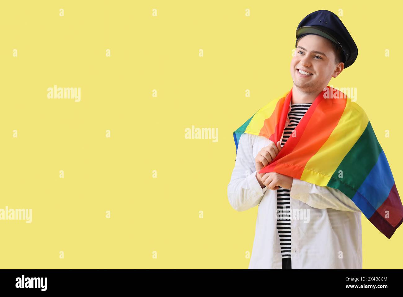 Male sailor with LGBT flag on yellow background Stock Photo - Alamy