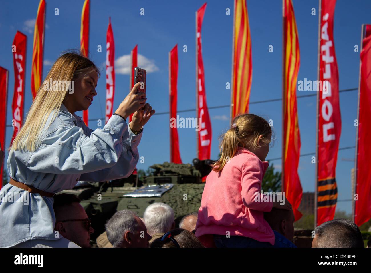 A woman takes photos at a newly opened exhibition of trophy military ...