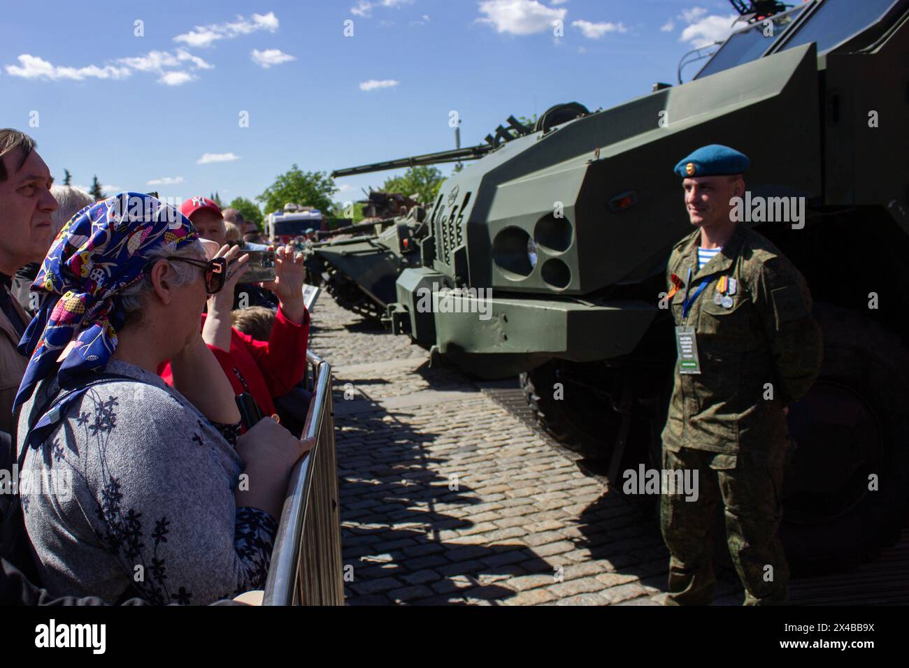 A Russian paratrooper stands next to a line of captured military ...