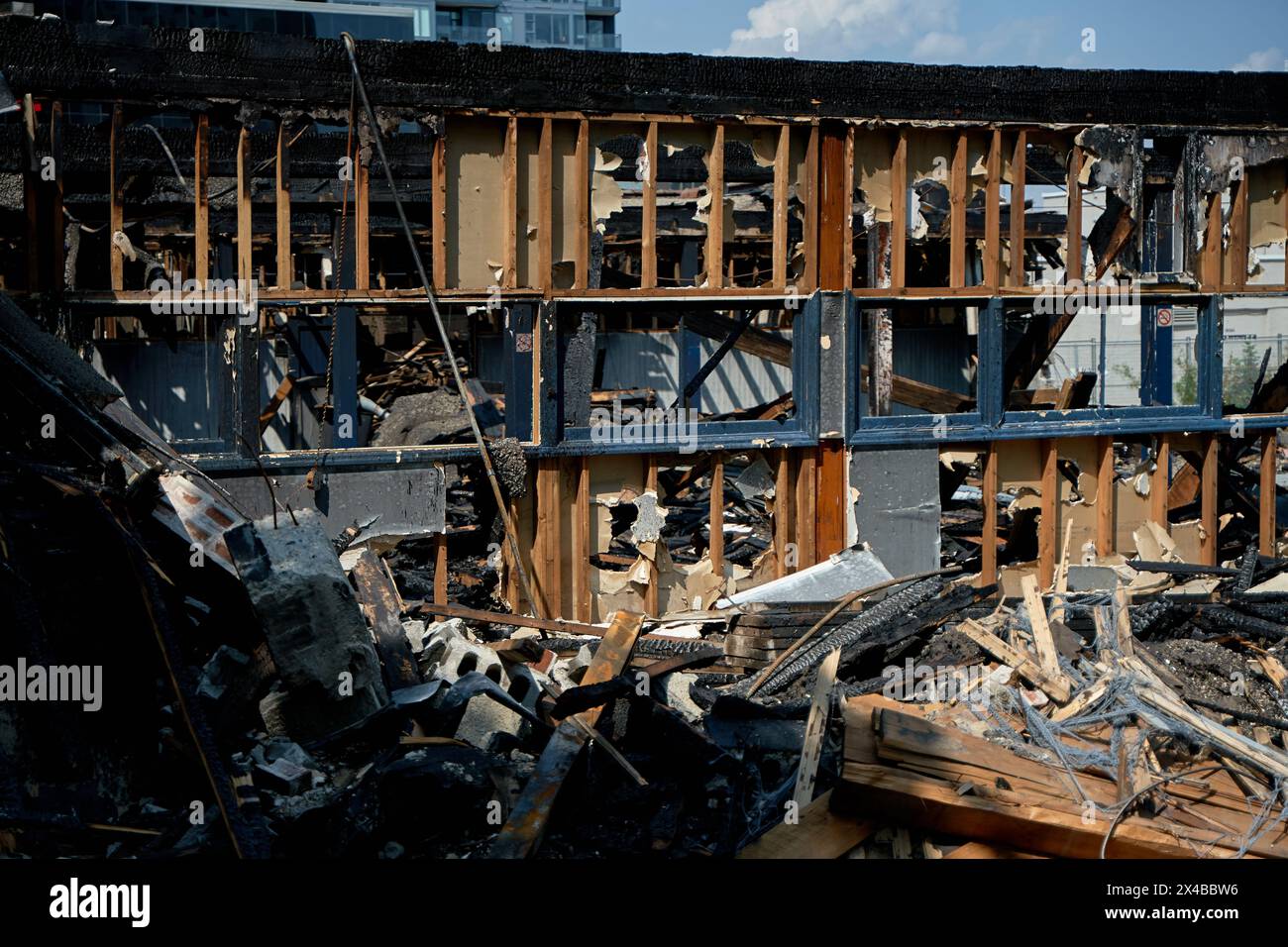 A burnt-out old wooden building after a fire. Charred beams after the ...