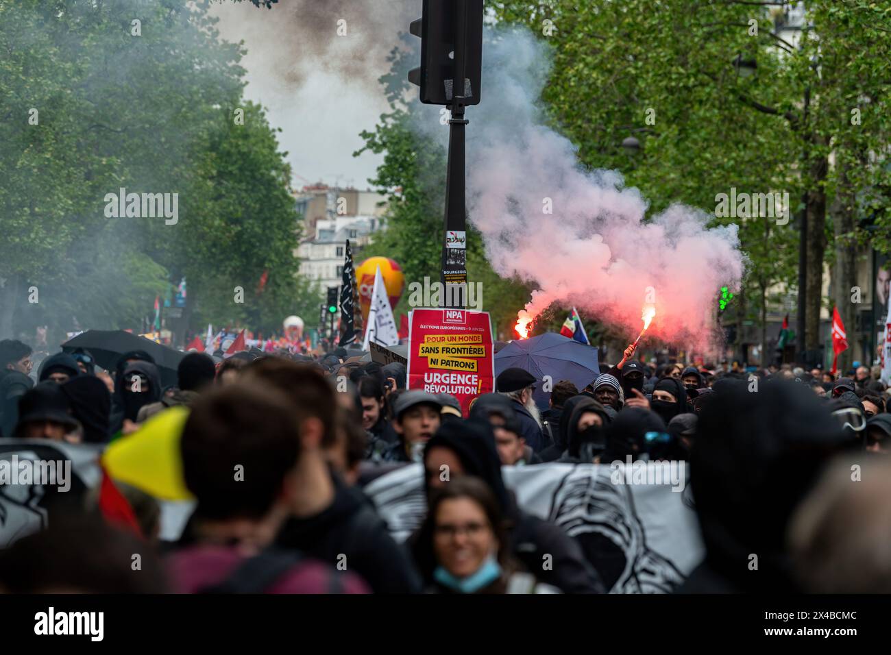 Protester hold burning flares over their heads during the annual ...