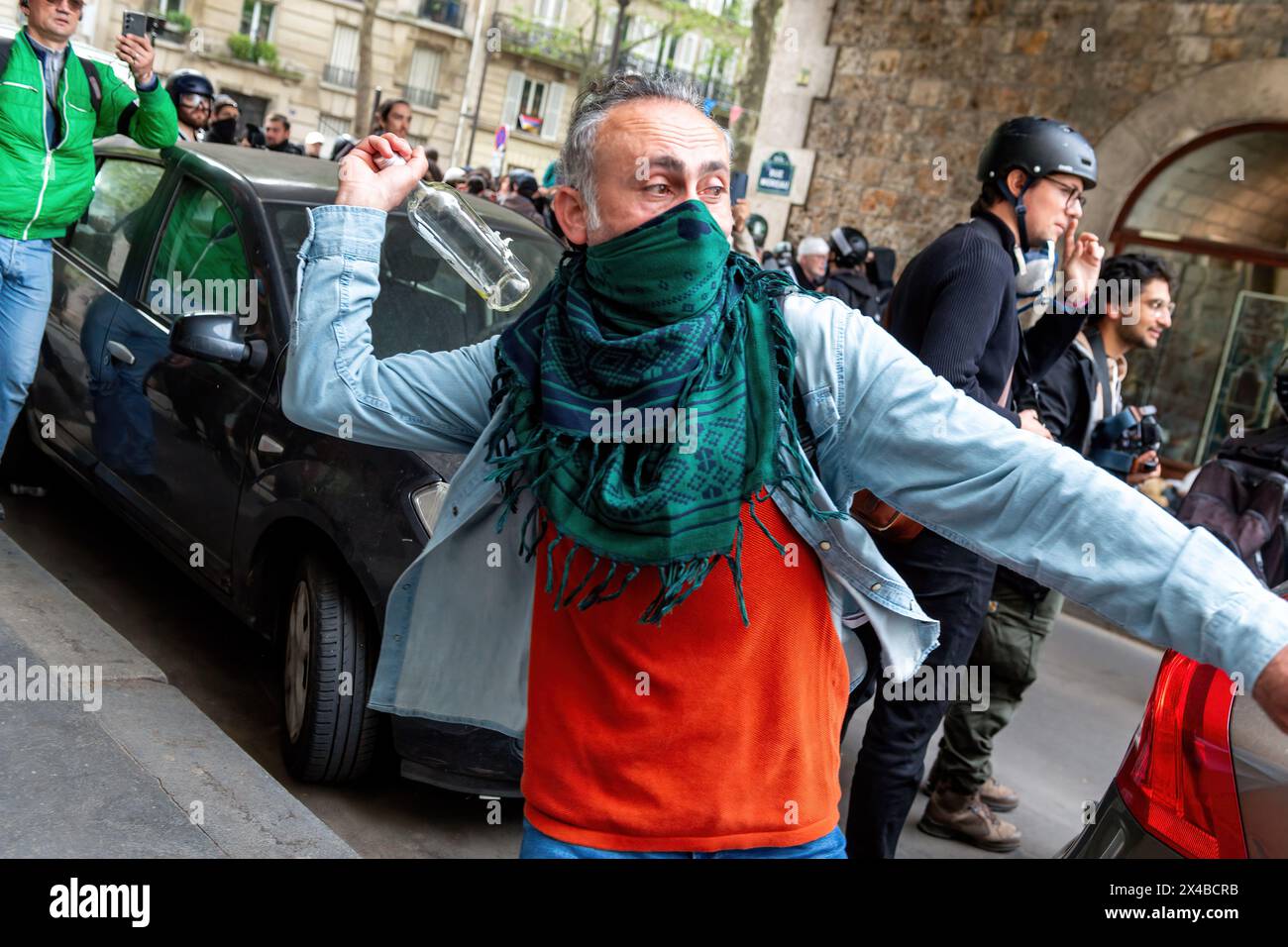 A protester throws a wine bottle towards police during the annual ...
