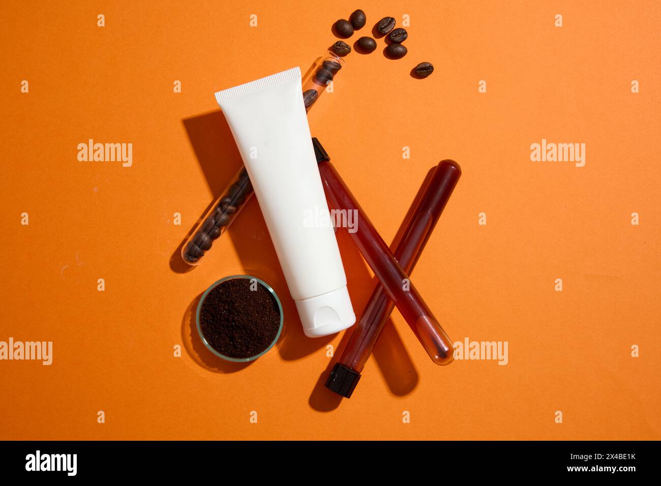A white plastic tube displayed on orange background with test tubes ...