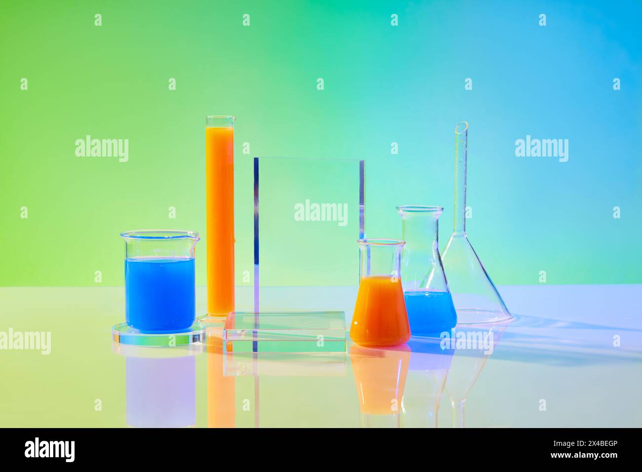 Orange and blue liquid contained inside laboratory glassware with empty ...