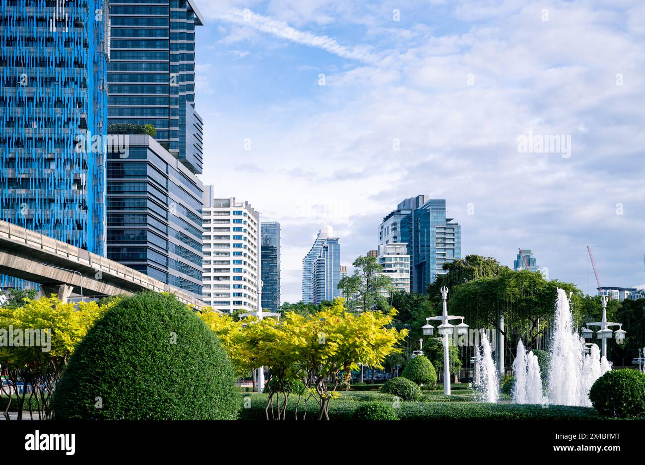 A city with tall office buildings and a central fountain. Sustainable ...