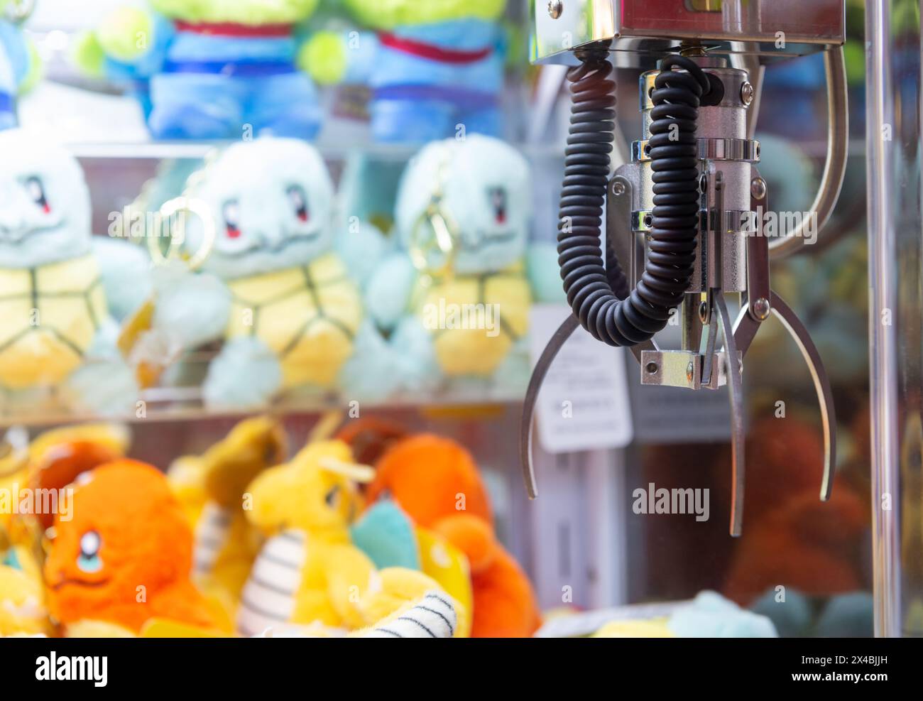 Claw machine game arcade entertainment background Stock Photo - Alamy