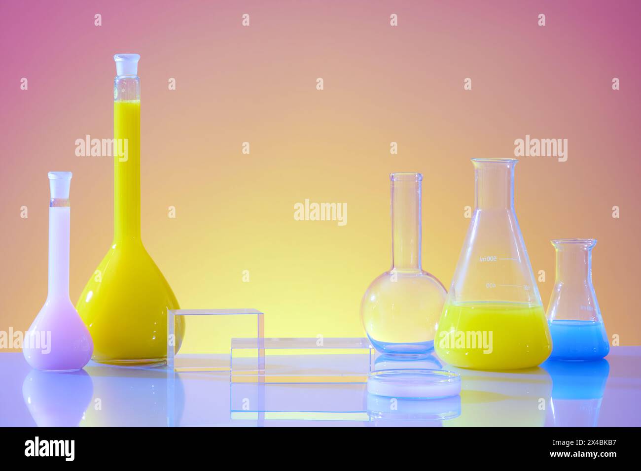 Front view of glass laboratory flasks containing color liquid displayed ...