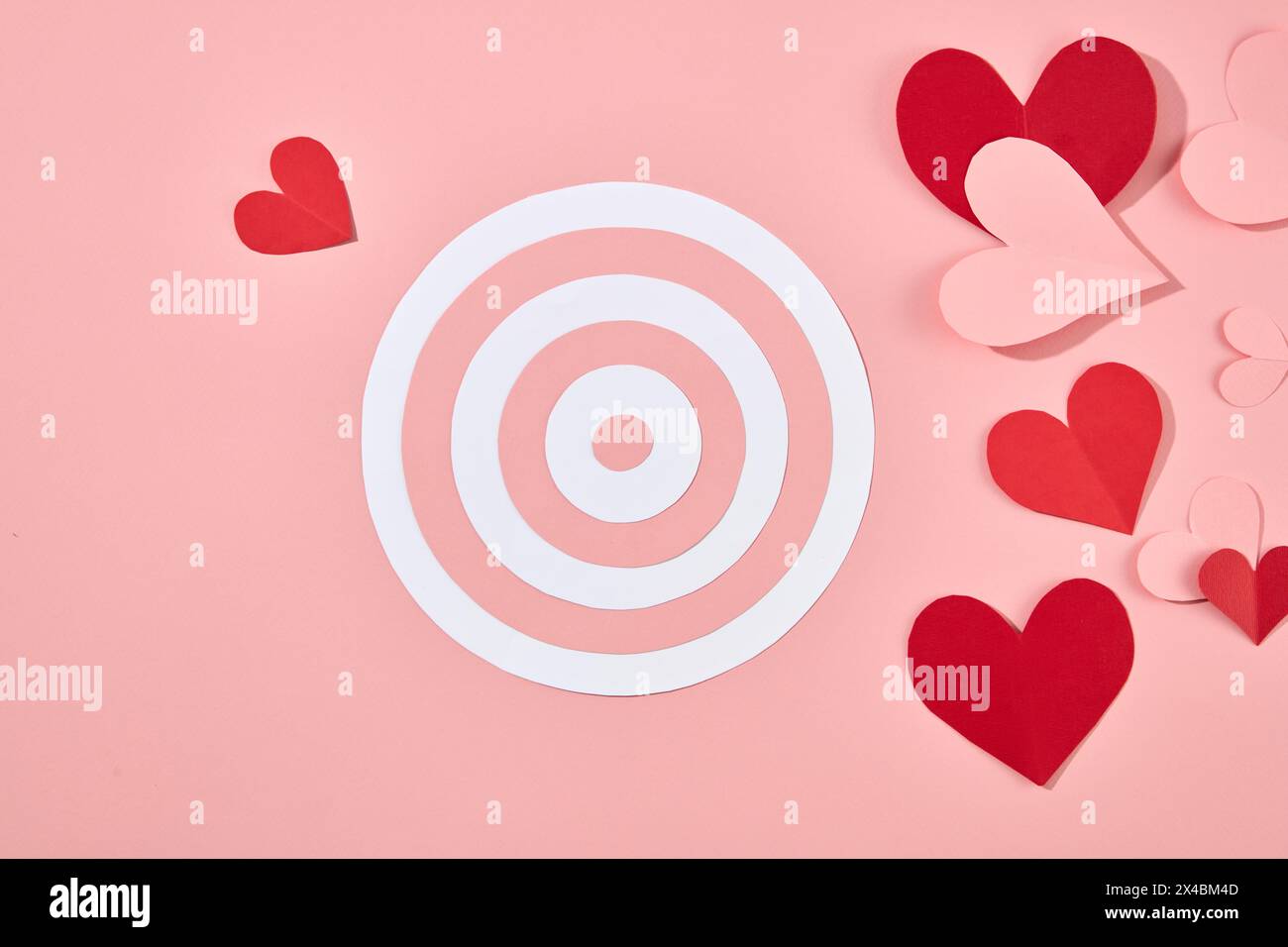 Top view of white bullseye decorated with pink and red heart in pink ...